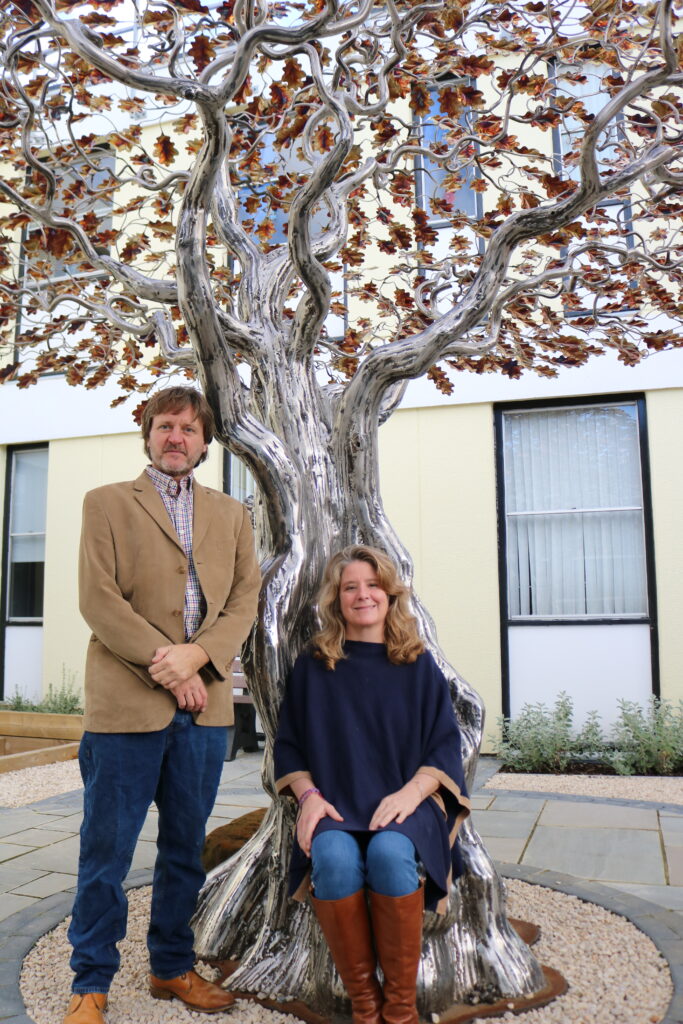 Mark Reed sculptor and wife Hannah ( seated) on Tree of Life sculpture ...